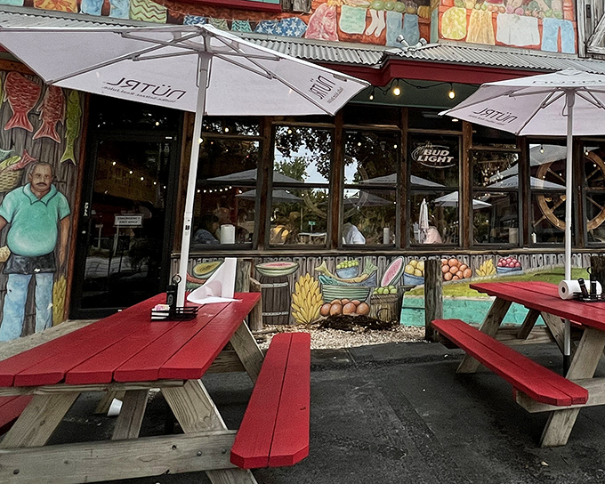 The colorful exterior of Fourth Street Shrimp Store welcomes you with vibrant murals and cherry-red picnic tables. Florida dining at its most authentically unpretentious.