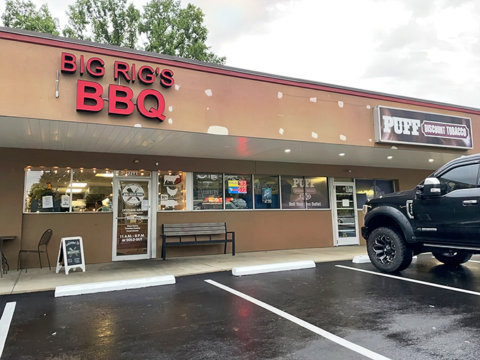 The bright red sign beckons like a lighthouse for the barbecue-starved, promising smoky salvation in an unassuming strip mall setting.