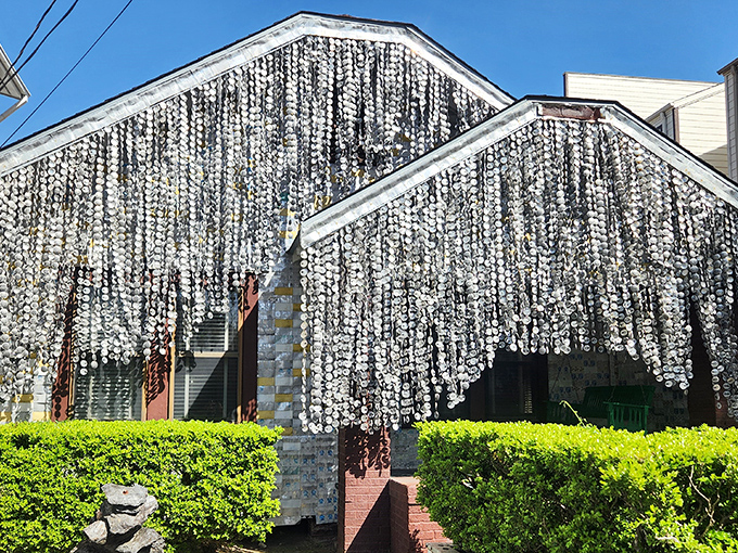 The shimmering curtains of beer can tops create a mesmerizing facade that catches sunlight like a disco ball from the 1970s.