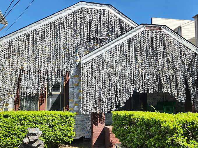 The shimmering curtains of beer can tops create a mesmerizing facade that catches sunlight like a disco ball from the 1970s.