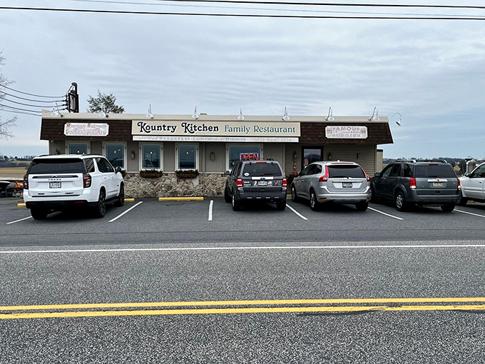 The unassuming exterior of Kountry Kitchen belies the culinary treasures within. Those hanging flower baskets aren't just for show—they're your first clue this place cares about the details.