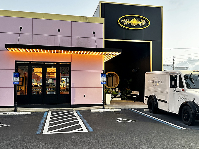 The Glass Knife's striking exterior blends modern architecture with a touch of whimsy&mdash;black panels meet that signature pink wall like formal wear accessorized with a playful pocket square.