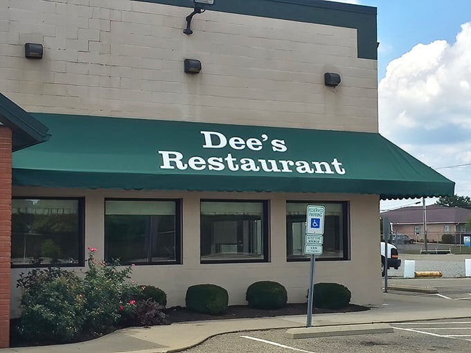 The unassuming exterior of Dee's Restaurant, with its signature green awnings, proves that culinary treasures often hide in plain sight.