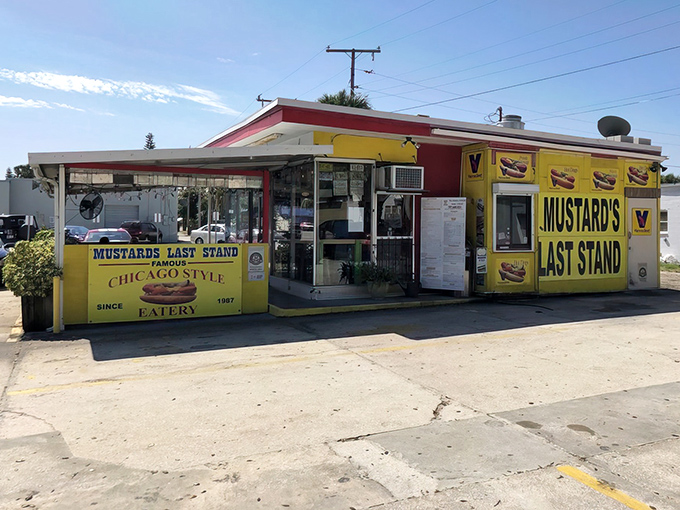 
The unassuming exterior of Mustard's Famous Hot Dogs hides a culinary treasure that proves the best things come in small, yellow-trimmed packages.
