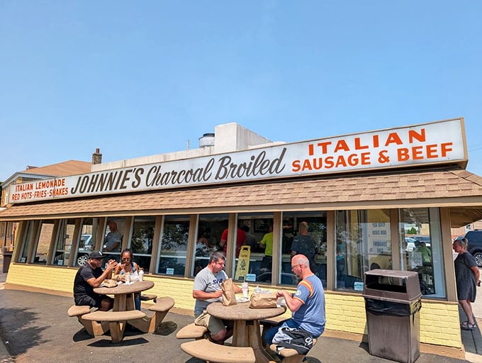 The yellow-brick fortress of beef worship stands unassuming yet magnetic, drawing devoted pilgrims to its outdoor tables like a culinary Stonehenge.