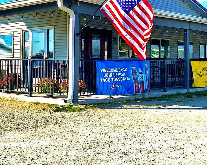 The American flag waves proudly outside 73 Grill, where the blue Pepsi banner announces Taco Tuesday like it's the social event of the week.