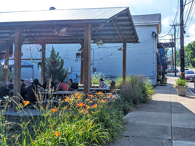The outdoor patio at Eli's BBQ is where summer dreams come true&mdash;string lights, wooden beams, and wildflowers creating the perfect backdrop for smoky indulgence. 