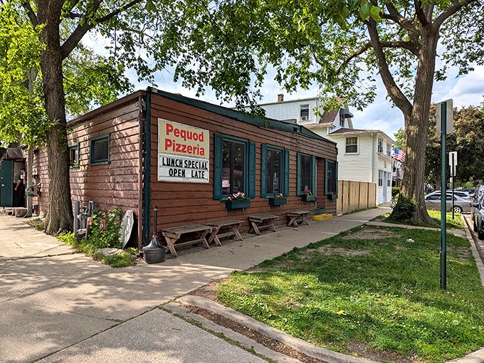 The unassuming wooden exterior of Pequod's Pizza hides culinary greatness like a superhero's secret identity. Pizza paradise in cabin form.