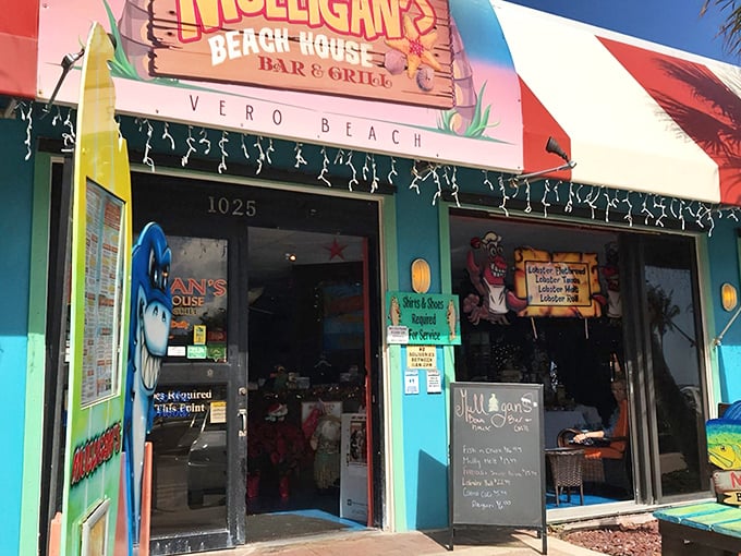 The vibrant entrance to Mulligan's Beach House beckons with tropical flair – like a cheerful postcard come to life under that perfect Florida sky.