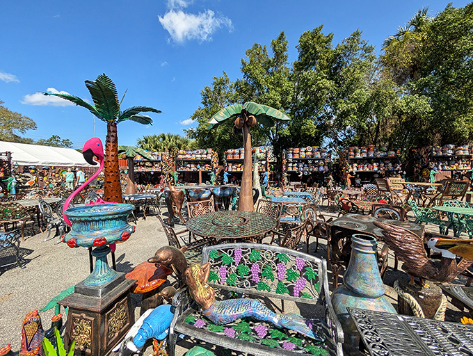 A whimsical wonderland where metal palm trees and pink flamingos hold court over an empire of garden treasures waiting to find their forever homes.