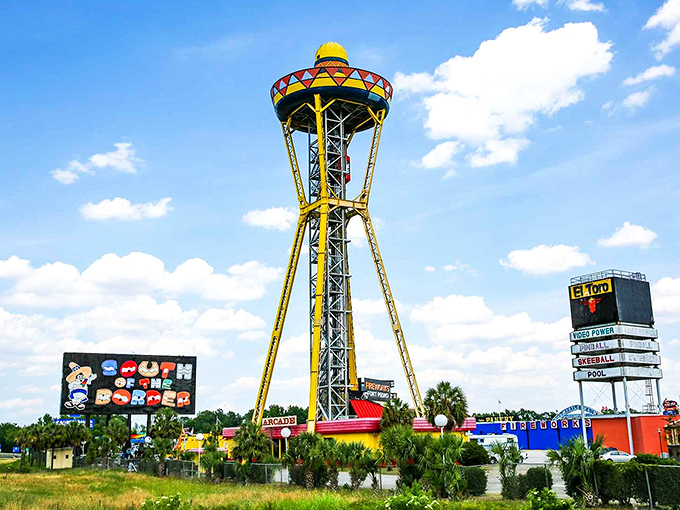 The iconic sombrero-topped observation tower stands like a technicolor sentinel, announcing "normal travel experiences end here!" It's visible for miles along I-95.