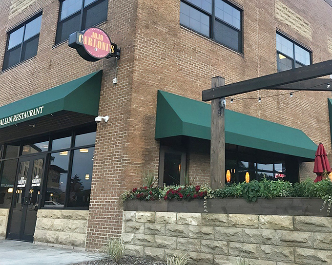 JoJo Carloni's welcoming brick exterior with signature green awnings stands like a beacon of Italian promise in Berea. The West Entrance beckons hungry travelers inside.