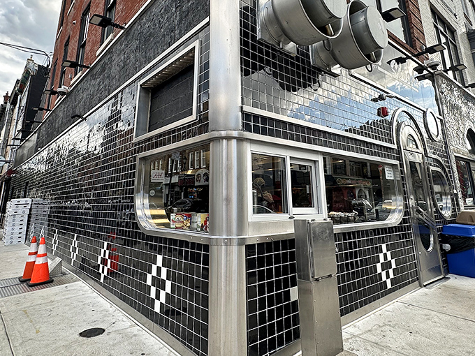 The iconic black and white tiled exterior of Jim's South St. stands like a cheesesteak beacon on Philadelphia's bustling South Street, promising sandwich salvation to all who enter.