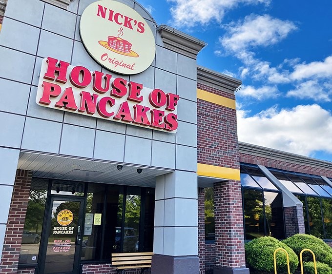That iconic red sign against Michigan's blue sky is like a breakfast lighthouse guiding hungry souls to pancake paradise.