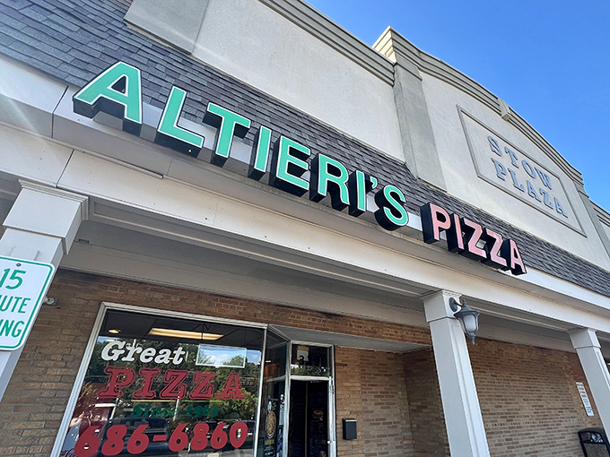 The teal and pink neon sign of Altieri's Pizza glows like a beacon of hope for the hungry in Stow Plaza. Comfort food paradise awaits!