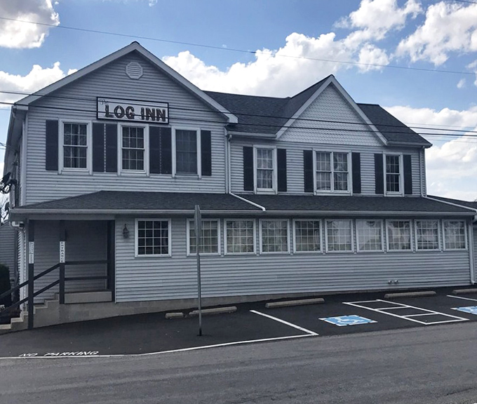 The unassuming exterior of The Log Inn belies the culinary treasures within. This historic Haubstadt landmark has been satisfying Hoosier appetites for generations.