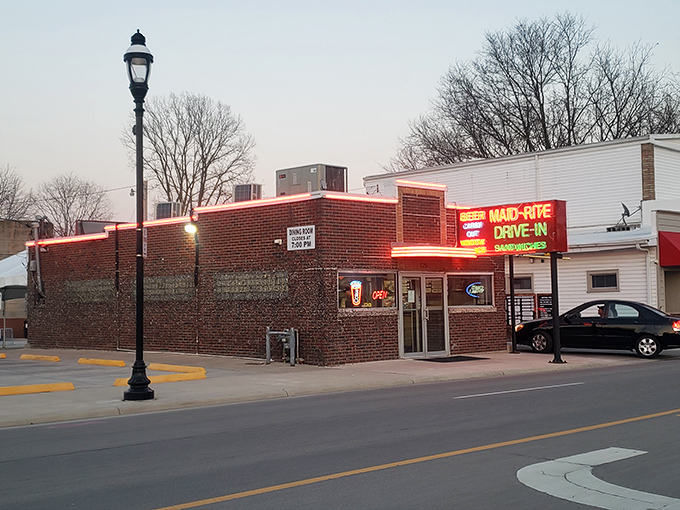 The neon beacon of Greenville! Maid-Rite's vintage sign promises three essential food groups: beer, sandwiches, and nostalgia&mdash;all available via drive-in window service.