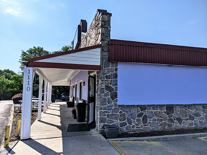 Stone walls and a welcoming porch make Sunrise Diner a roadside beacon for hungry travelers. The American flag flutters proudly, promising patriotic portions inside.
