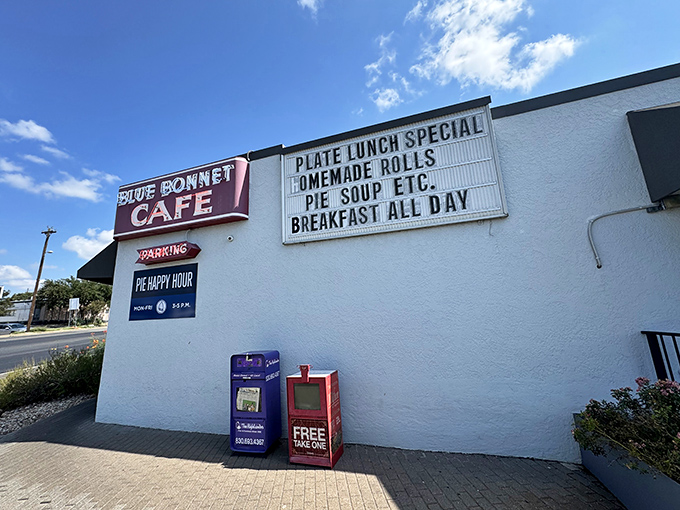The unassuming exterior of Blue Bonnet Cafe stands like a beacon of hope for hungry travelers. That "Pie Happy Hour" sign is basically a bat signal for dessert enthusiasts.