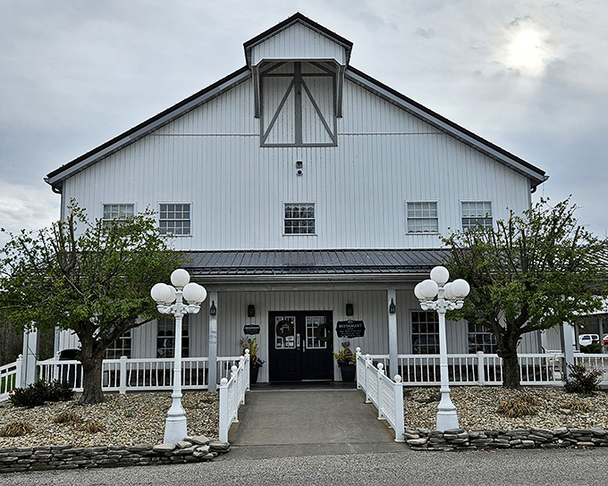 The stately white exterior of Gasthof Amish Village stands like a culinary lighthouse, beckoning hungry travelers with the promise of comfort food that transcends trends.