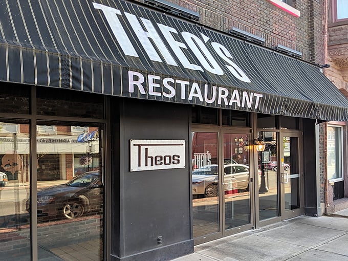 The classic black awning of Theo's Restaurant stands as a beacon of culinary comfort in downtown Cambridge, promising honest food without pretension.
