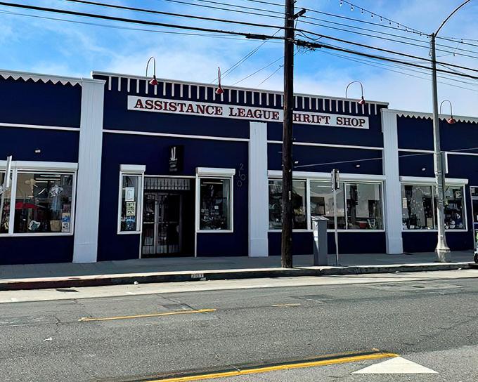 The navy blue fa&ccedil;ade of Assistance League Thrift Shop stands proudly on the street, like a treasure chest waiting to be opened by curious bargain hunters.