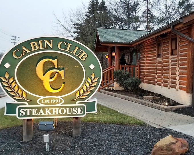The rustic log cabin exterior of Cabin Club isn't just charming&mdash;it's a promise of the cozy, wood-scented culinary adventure waiting inside.