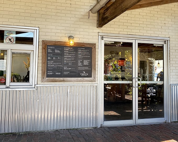 The unassuming exterior of Timoti's Seafood Shak beckons with rustic charm. That corrugated metal and wooden menu board? Pure Florida coastal casual.