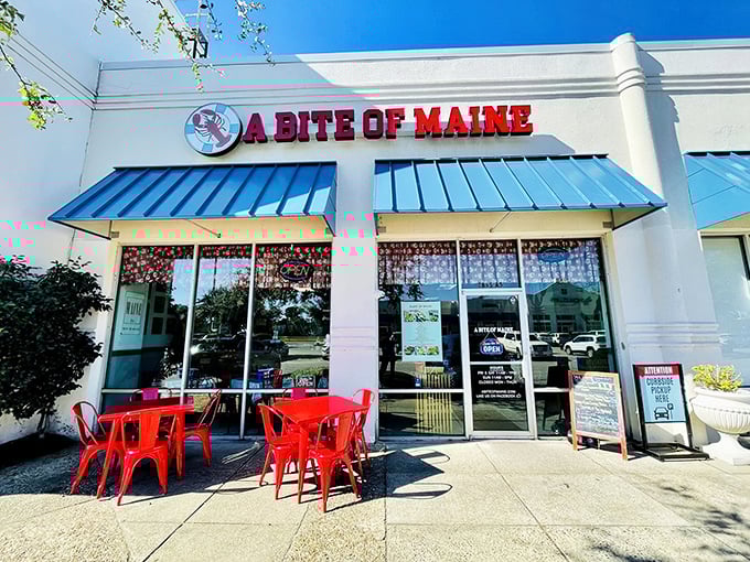 The bright red sign against the blue awning is like a lighthouse beacon for seafood lovers lost in a sea of chain restaurants.