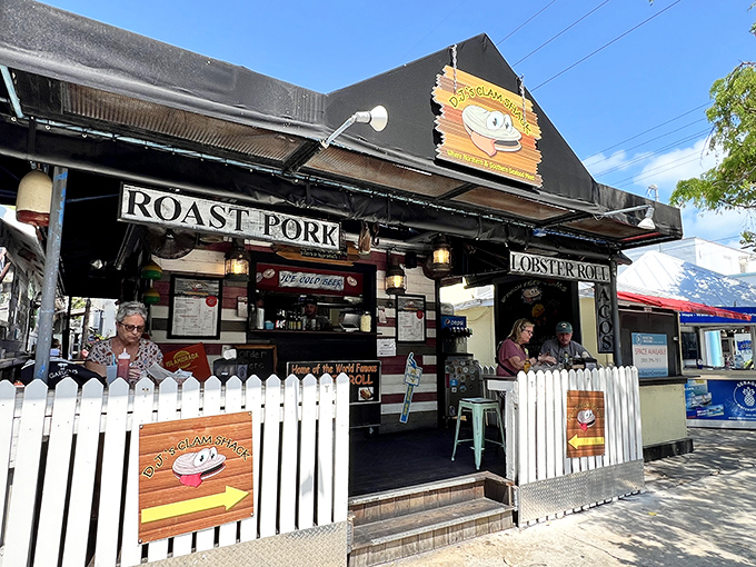 The white picket fence isn't keeping anyone out—it's practically inviting you into this slice of seafood heaven on Duval Street.