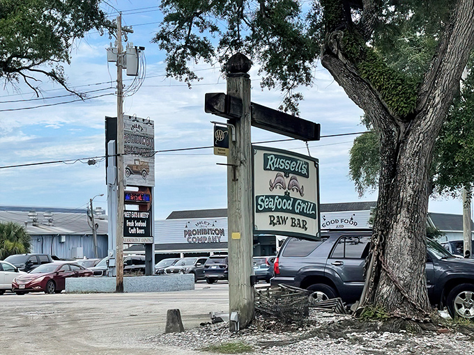 The unassuming wooden sign at Russell's Seafood Grill promises no frills, just seafood excellence. Like finding buried treasure without needing a fancy map.