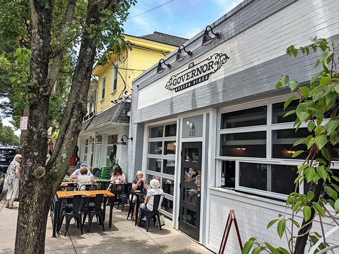 The Governor's crisp white exterior and inviting patio seating create the perfect small-town vibe on Milford's charming Main Street.