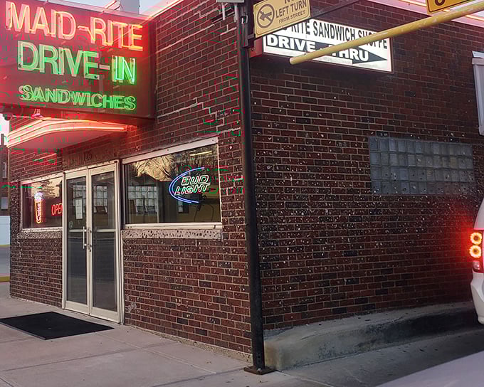 The neon glow of Maid-Rite's vintage sign beckons like a lighthouse for hungry travelers seeking comfort food salvation in Greenville.