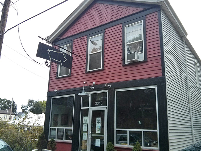 The unassuming burgundy exterior of Eli's BBQ stands like a beacon of hope for hungry travelers. Behind that modest facade lies smoky paradise.