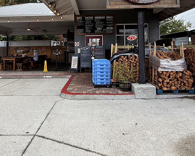 The barbecue beacon of Cocoa Village, with stacks of oak firewood that aren't just decoration&mdash;they're a promise of authentic, slow-smoked goodness to come. 