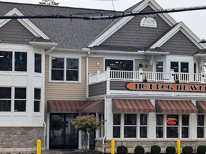The welcoming exterior of Hot Dog Heaven stands like a beacon of comfort food in Amherst, complete with charming striped awnings that practically whisper "come get your chili dog fix."
