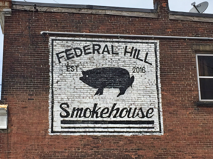 The unassuming brick corner that houses barbecue greatness. That painted pig logo isn't just decoration&mdash;it's a beacon calling hungry souls home.