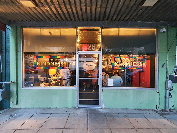 The turquoise facade of Pooleside Pies glows like a beacon for hungry souls, promising comfort in neon-lit form.