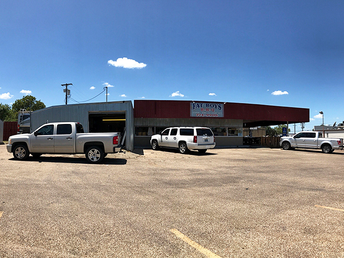 The unassuming red exterior of Fat Boy's BBQ stands like a smoke signal to hungry travelers. Texas wisdom: the plainer the building, the better the barbecue inside.