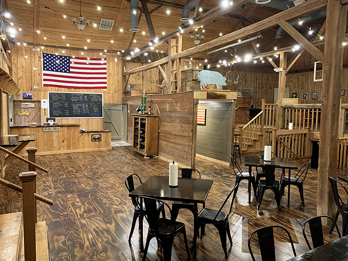 The rustic red exterior of Big Dan's BBQ belies the smoky treasures within. Those pink picnic benches? Nature's way of saying "sit here after your meat sweats begin."
