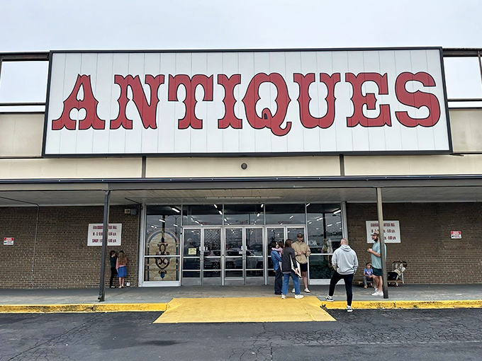 The red "ANTIQUES" sign beckons like a siren call to treasure hunters. No fancy frills needed when what's inside speaks volumes.
