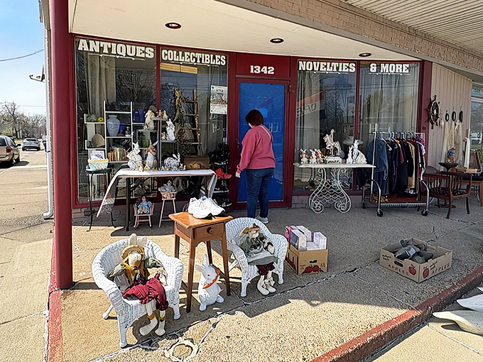 The blue door beckons like a portal to the past, with treasures spilling onto the sidewalk. White wicker furniture and vintage collectibles offer just a hint of what awaits inside.