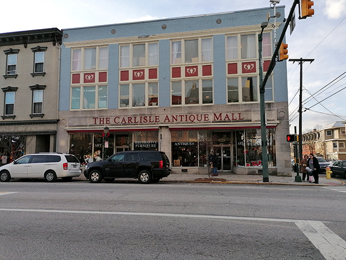 The iconic blue facade of The Carlisle Antique Mall stands proudly on Hanover Street, a beacon for treasure hunters in Pennsylvania's Cumberland Valley.
