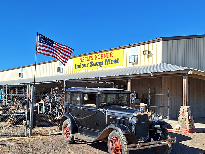 The bright yellow sign of Neely's Korner beckons like a desert mirage, promising treasures within. Desert artwork and wind chimes hint at the eclectic offerings awaiting inside.