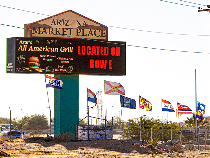 American flags flutter above white canopies at Arizona Market Place, where treasure hunting begins under the brilliant Yuma sky.