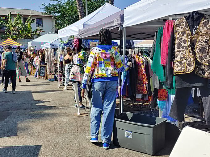 White canopies stretch into the distance like a modern-day bazaar, where treasure hunters navigate the narrow pathways between vendors under classic LA palm trees.