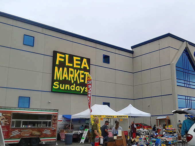 The iconic yellow "FLEA MARKET Sundays" sign beckons like a treasure map X marking the spot. Weekend adventures await beneath.
