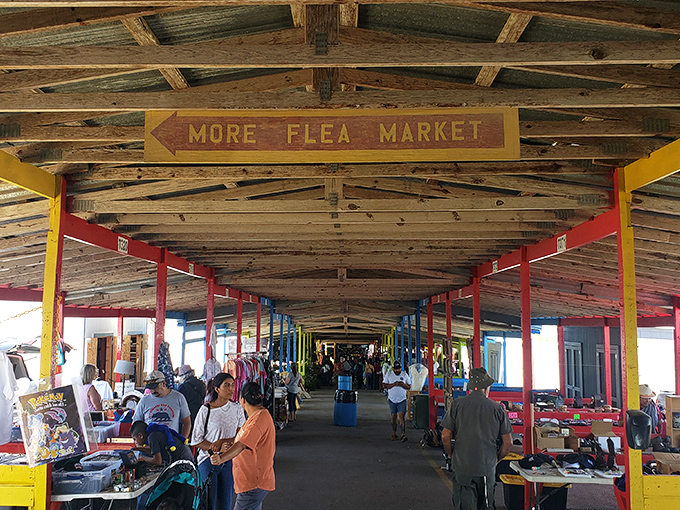 The sign says "MORE FLEA MARKET" and honestly, has a more perfect directive ever existed? Treasure hunters navigate this covered wonderland of possibilities.