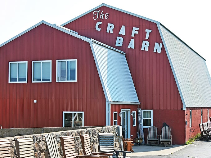 The Craft Barn's crimson exterior stands tall against the Wisconsin sky like a beacon for creativity-seekers. Adirondack chairs invite weary shoppers to rest their bargain-hunting legs.