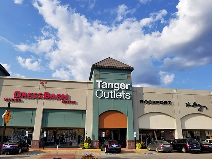 The retail promised land beckons with its iconic green tower. Dress Barn and Rockport stand ready to welcome bargain hunters into shopping paradise.